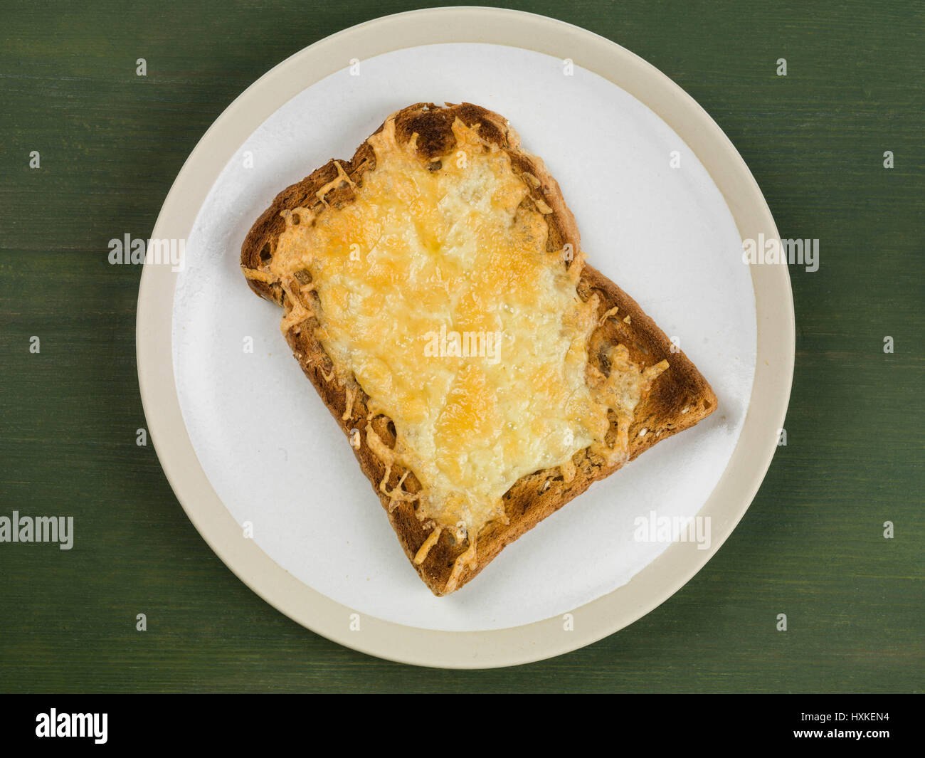 Single Slice of Cheese on Toasted Bread Against a Green Background ...