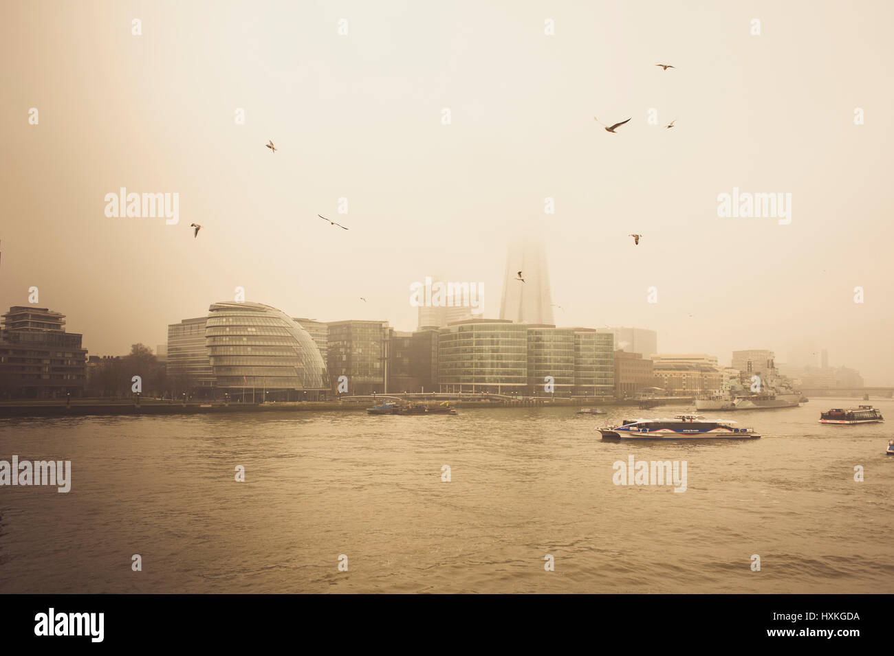 View of the London under the fog from Tower Bridge with the City Hall ...