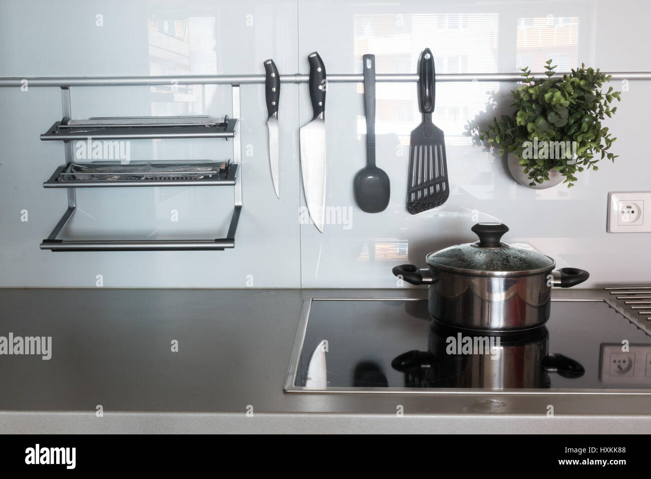 Modern kitchen in grey color at home with kitchenware Stock Photo - Alamy