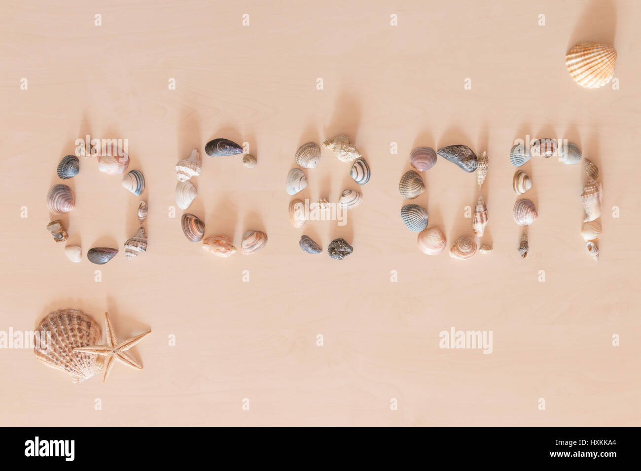 OCEAN words by sea shell on light wooden background Stock Photo - Alamy