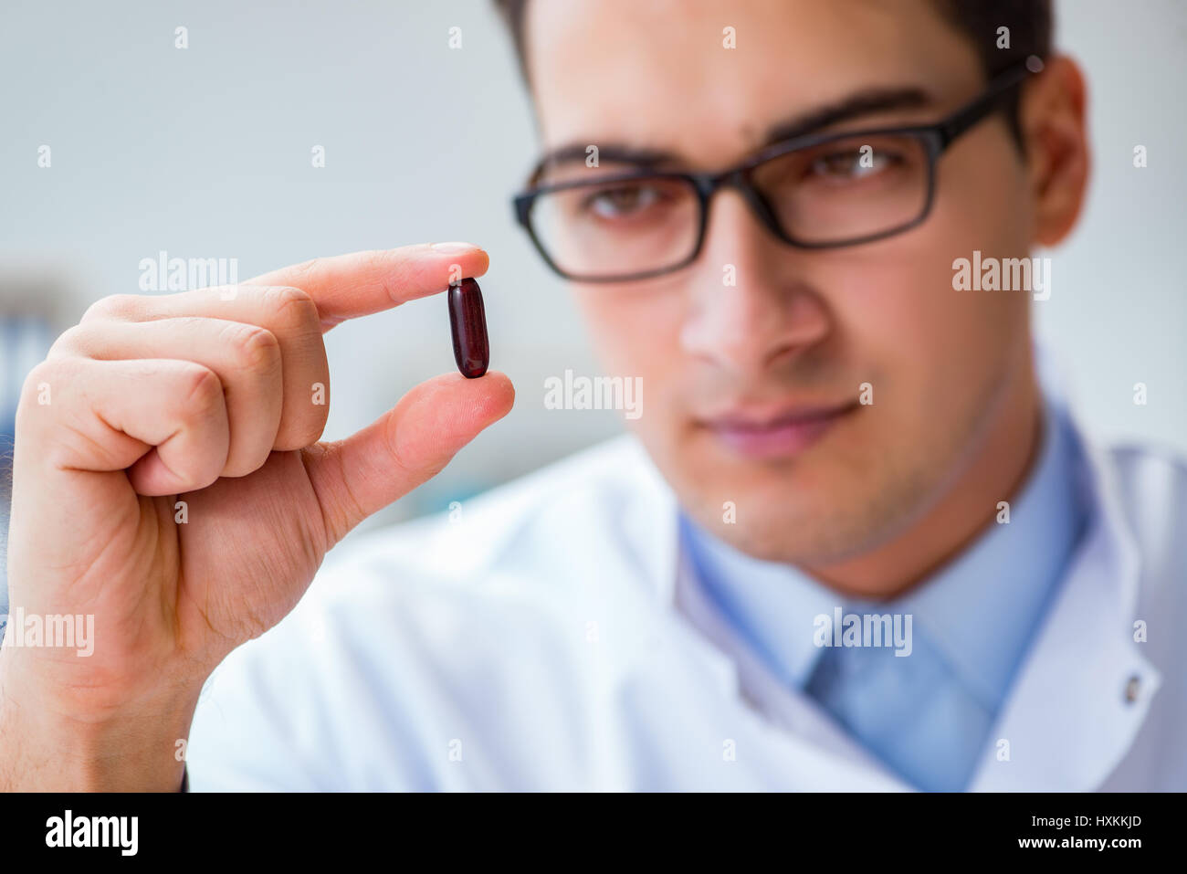 Doctor holding medicines in the lab Stock Photo - Alamy