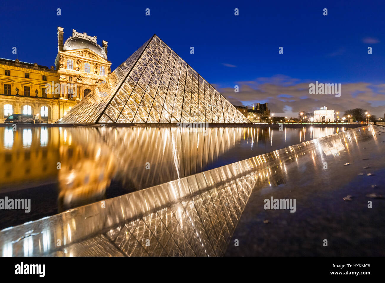 The Louvre Museum and reflection pond at night in Paris Stock Photo - Alamy