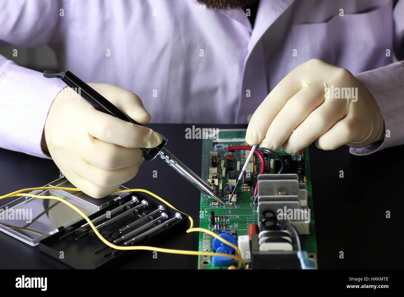 Male worker soldering cable hi-res stock photography and images - Alamy