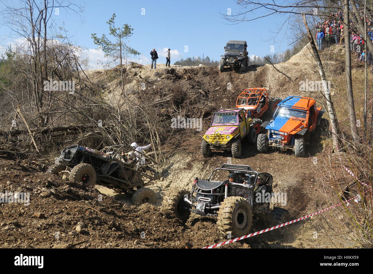 Off-road car driving uphill, two all-terrain vehicles are fixed by ...