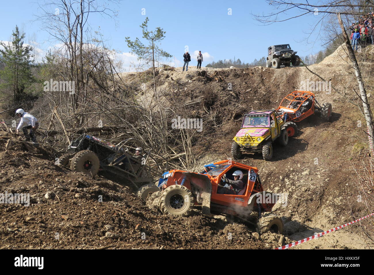 Off-road car driving uphill, two all-terrain vehicles are fixed by ...