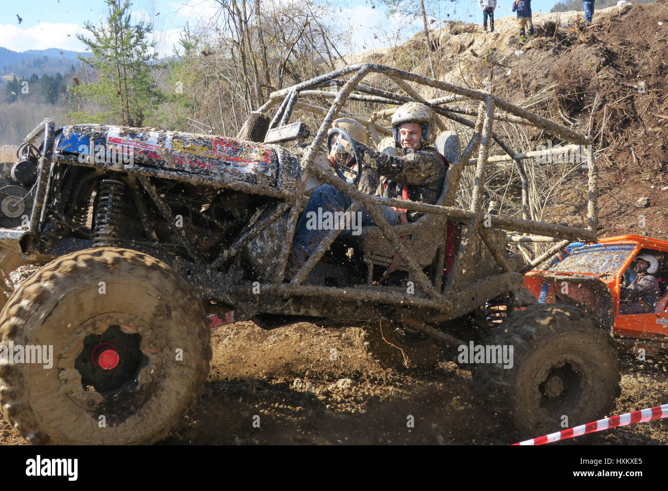 A mud is splashing when all-terrain vehicle with full gas drove uphill ...