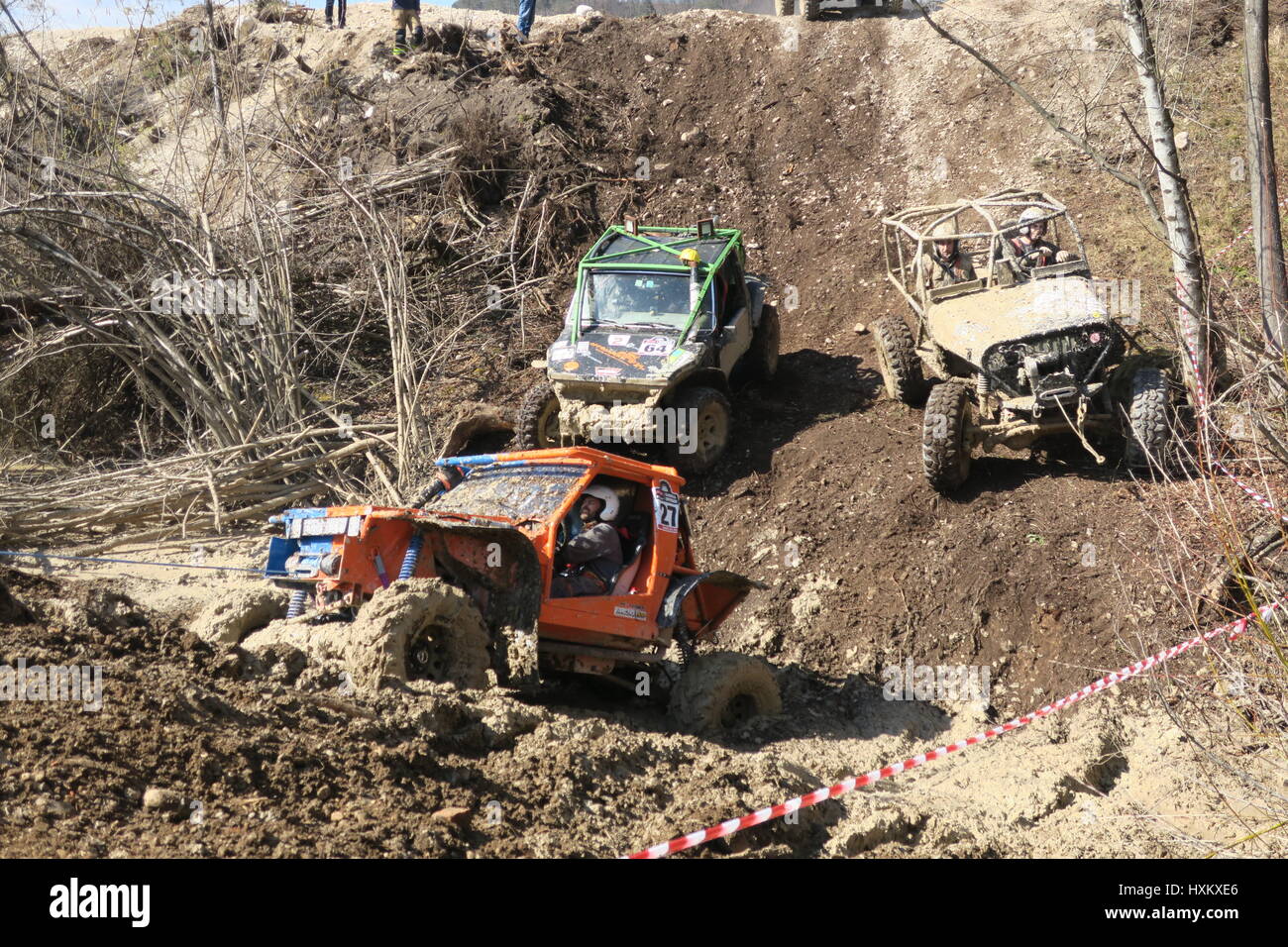 A off-road car is pulled uphill by hydraulics of an excavator, an all ...