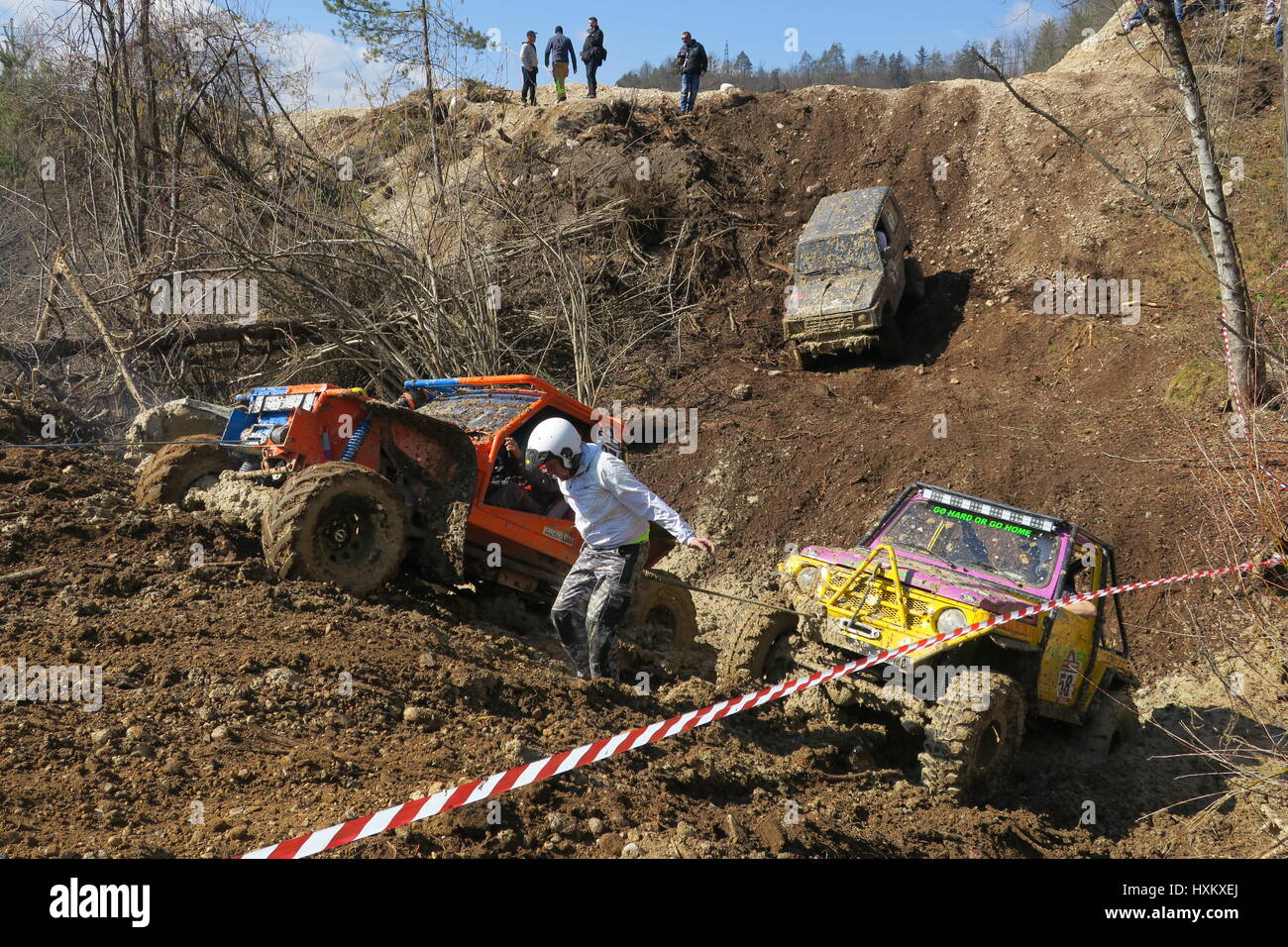 Off-road car is pushed uphill, a co-driver of an all-terrain car is ...