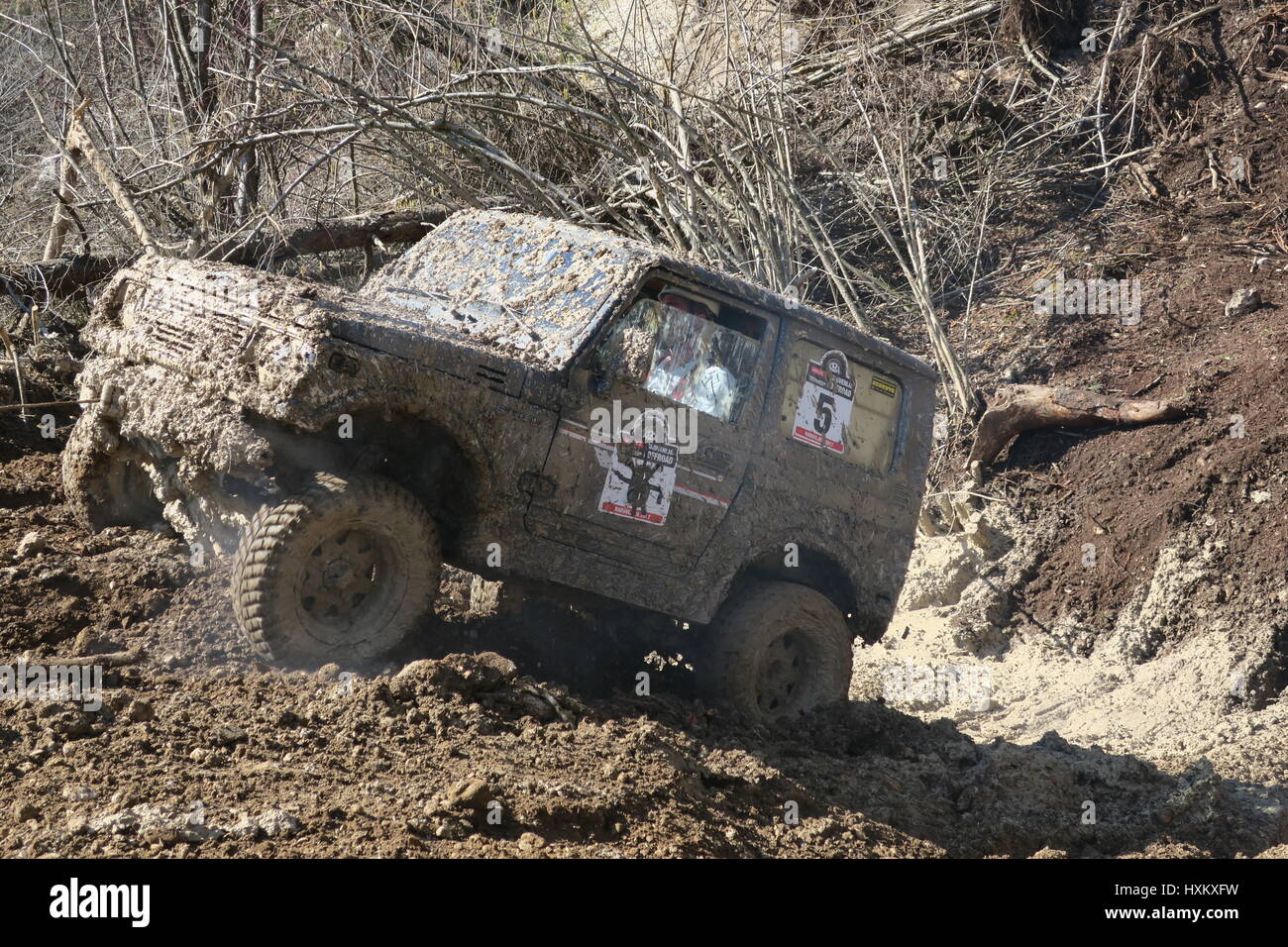 A close up of a very muddy all-terrain vehicle managed to drive over ...