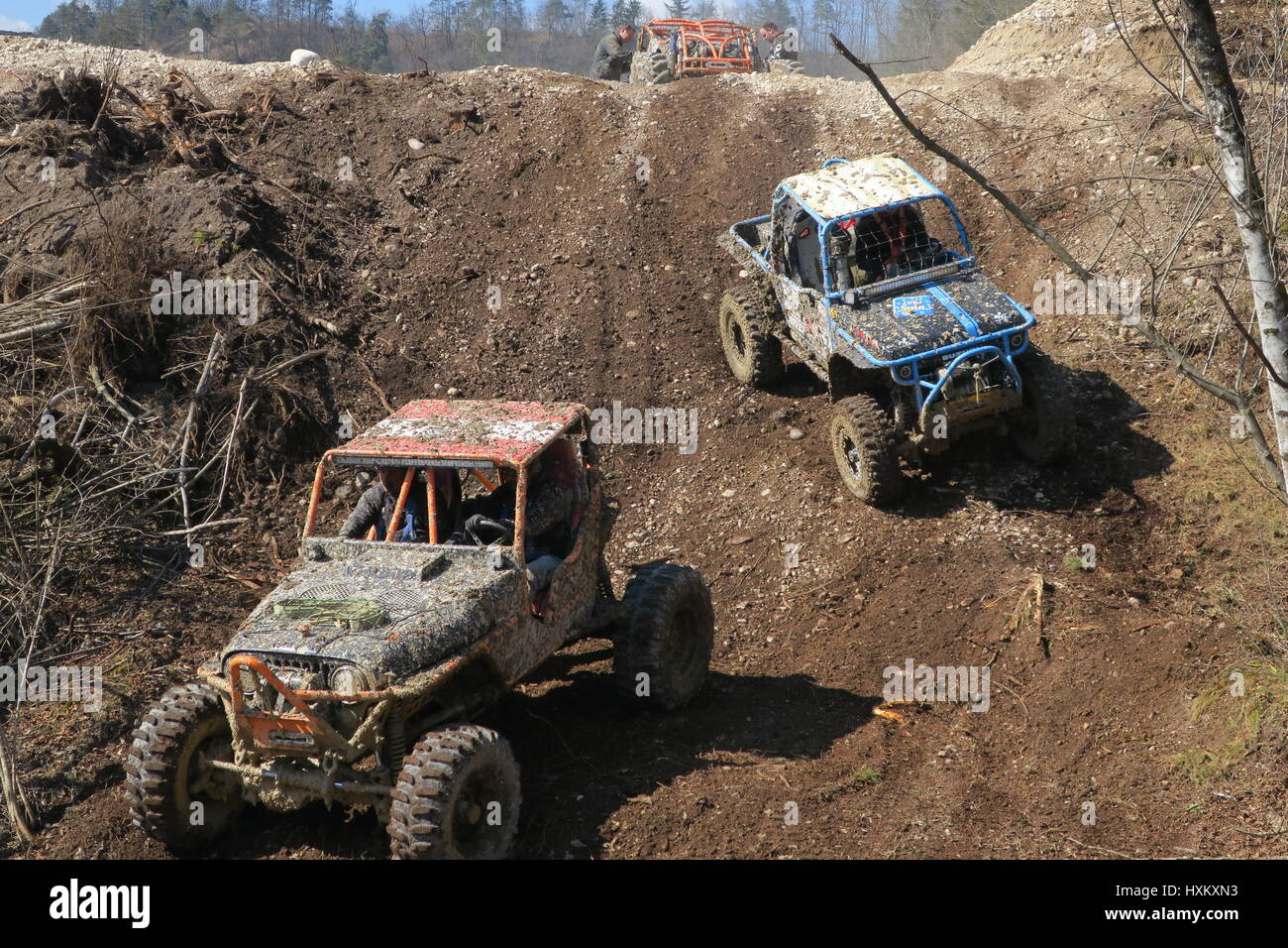 The foue-wheel drive and the aii-terrains vehicle are driving downhill ...