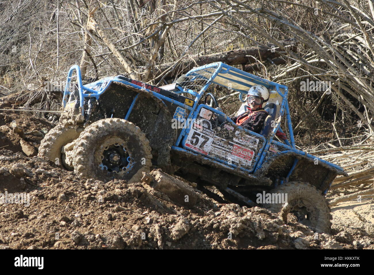 The off-road car, fixed with steel wire is pulled uphill by the help of ...