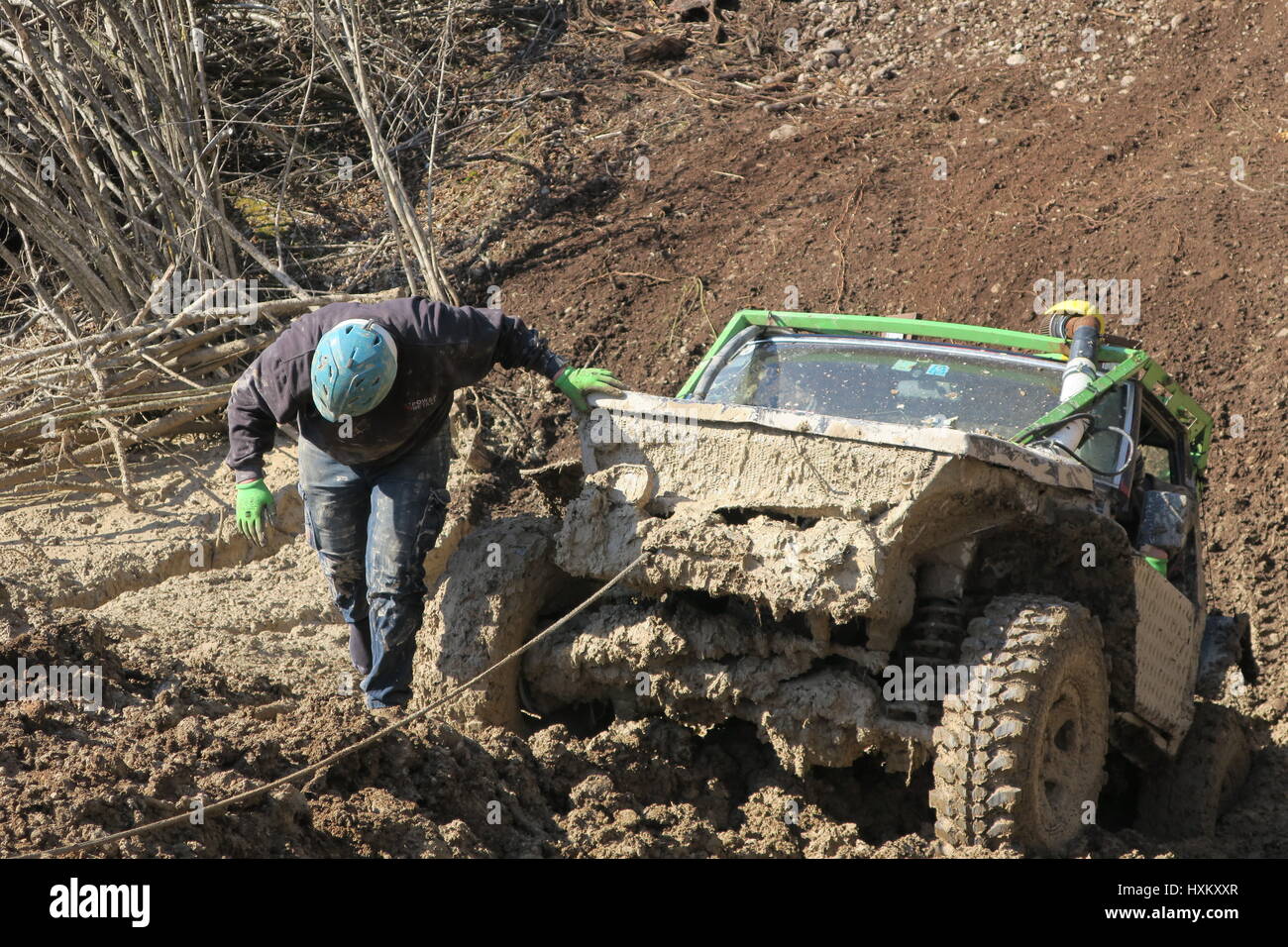 He is trying to pull the off-road car by escevator and steel wire and ...