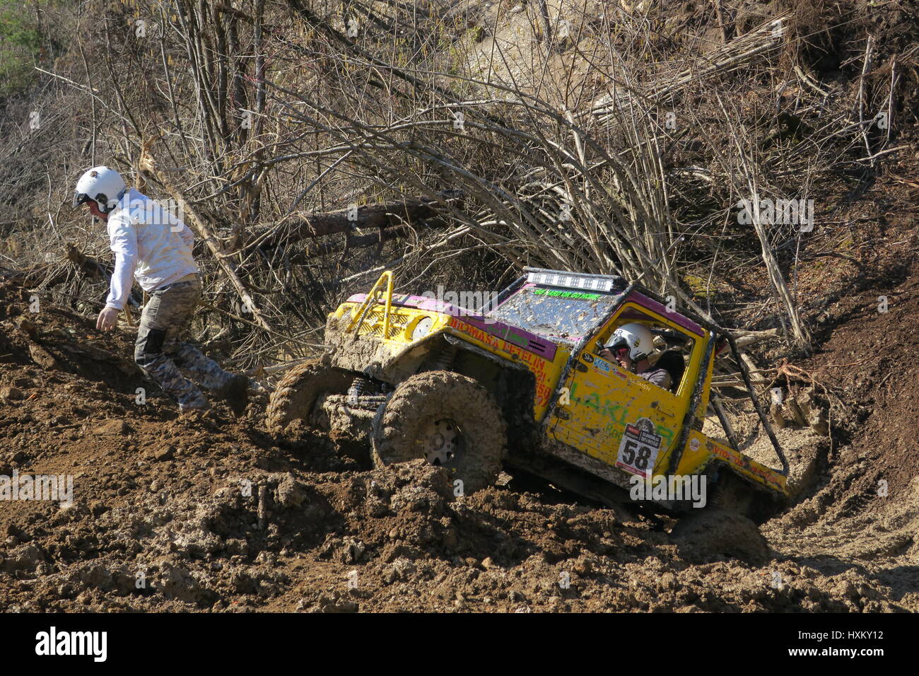 The off-road car is stuck on a muddy hill. It needs a steel wire and ...