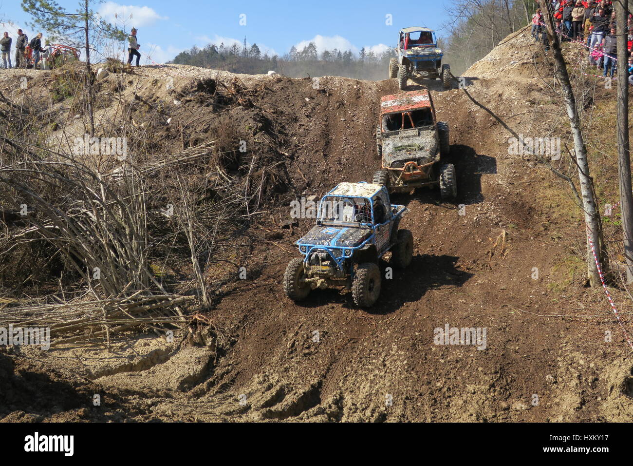 Three off-road cars driving downhill at a off-road race 4x4 drive ...