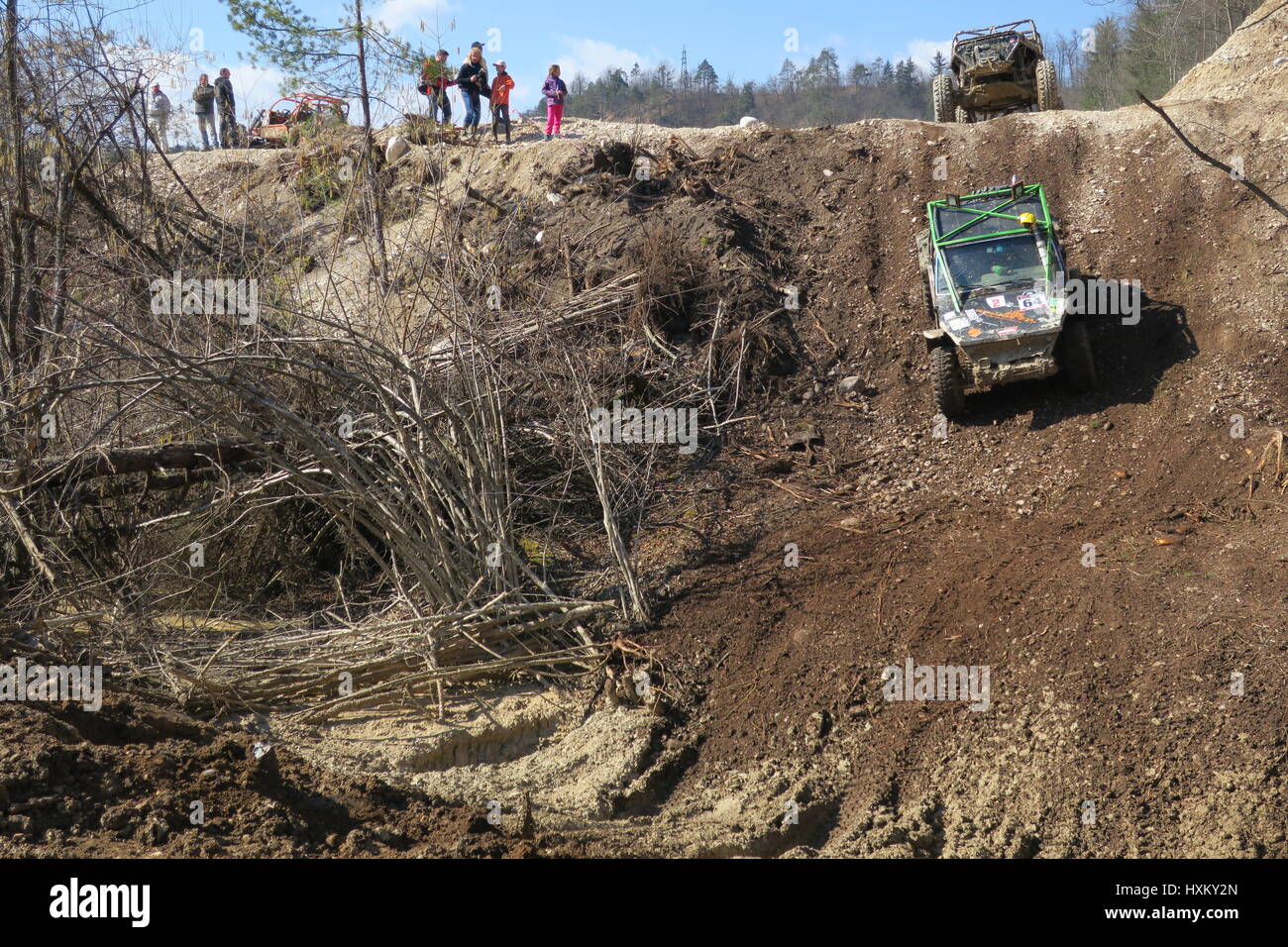 The off-road car is driving downhill towards a muddy trench on off road ...
