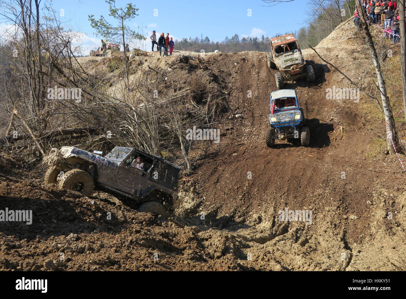 Two off-roads cars are waiting on a downhill for all-terrain vehicle to ...