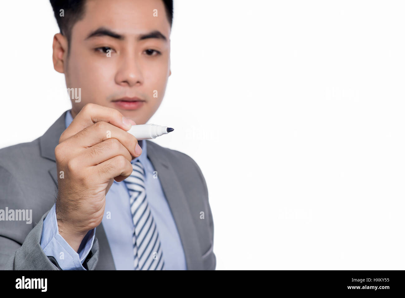 Business man writing with marker writing something on glass board ...