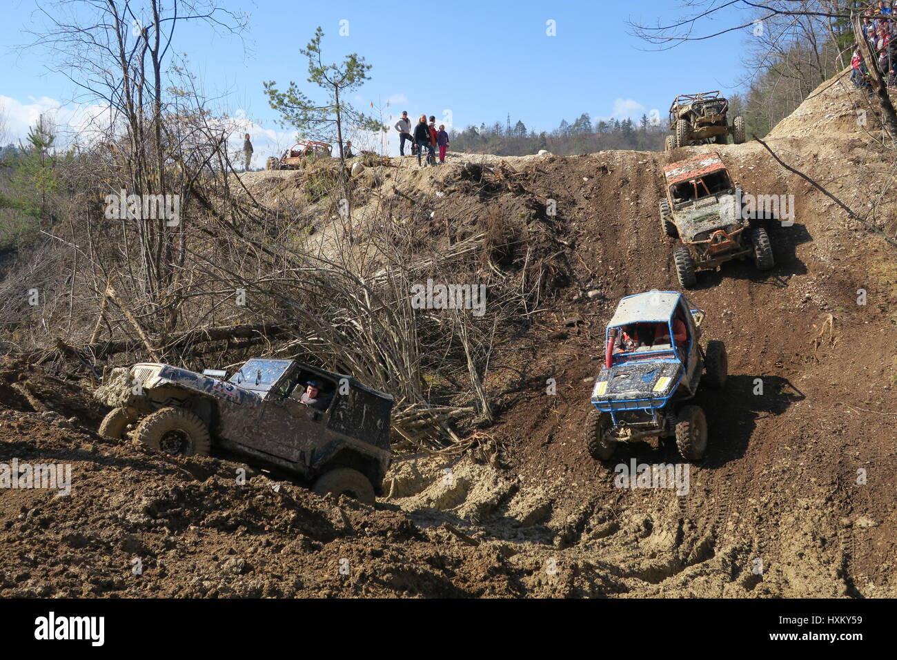 An all-terrain vehicle in driving uphill meanwhile three off-roads cars ...