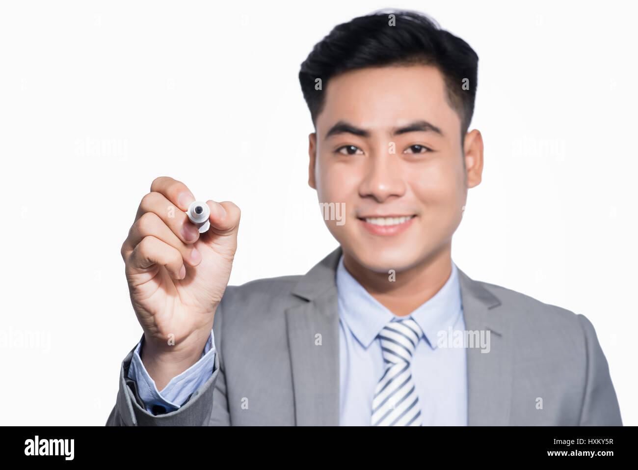Business man writing with marker writing something on glass board ...