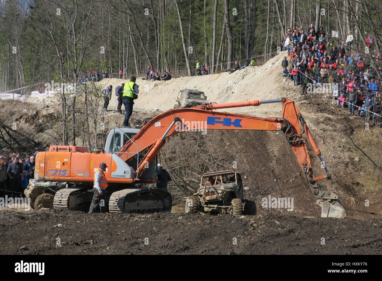 An excavator for pulling the off-road cars out of the muddy trench ...