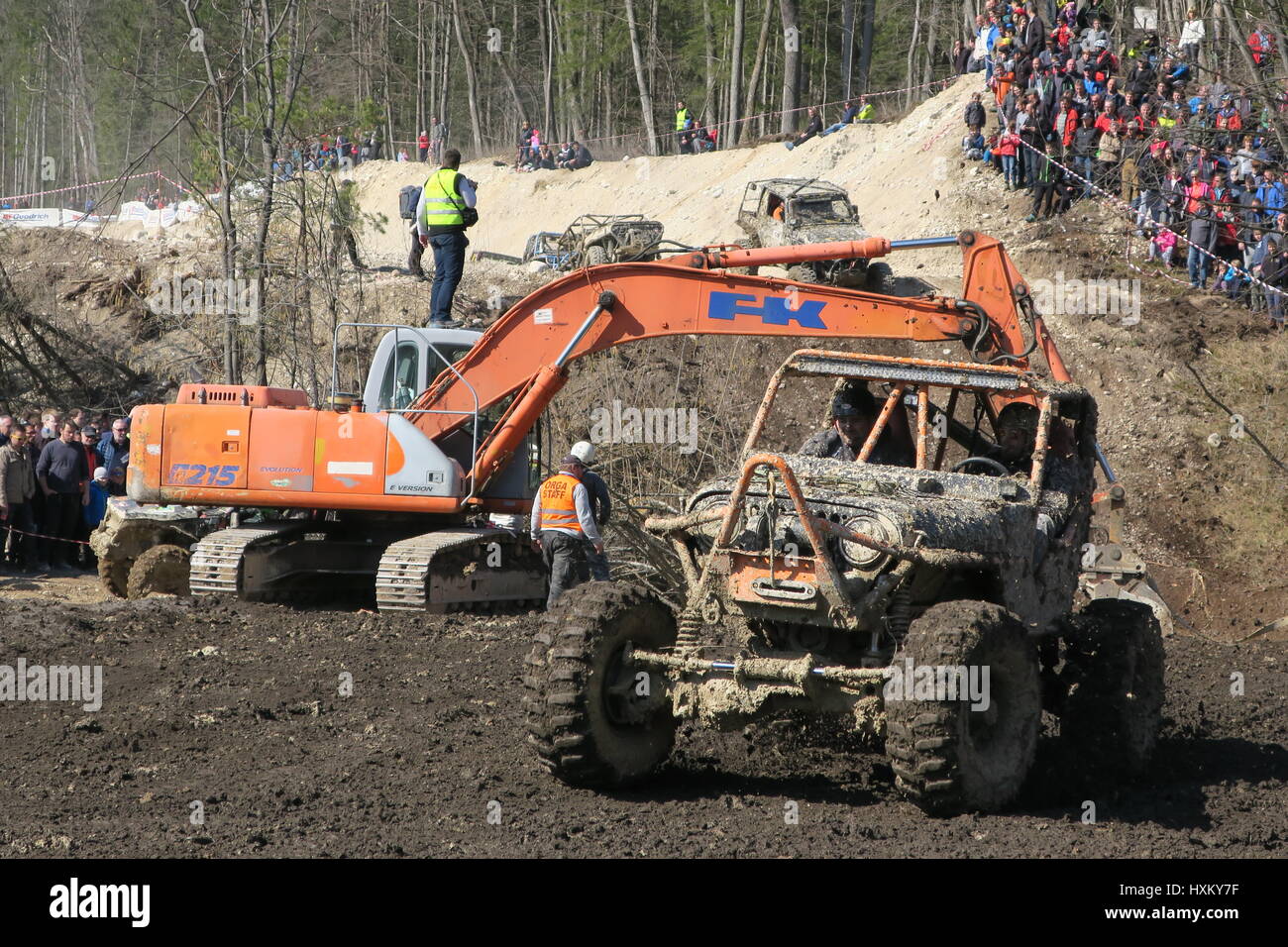 An excavator for pulling the off-road cars out of the muddy trench ...