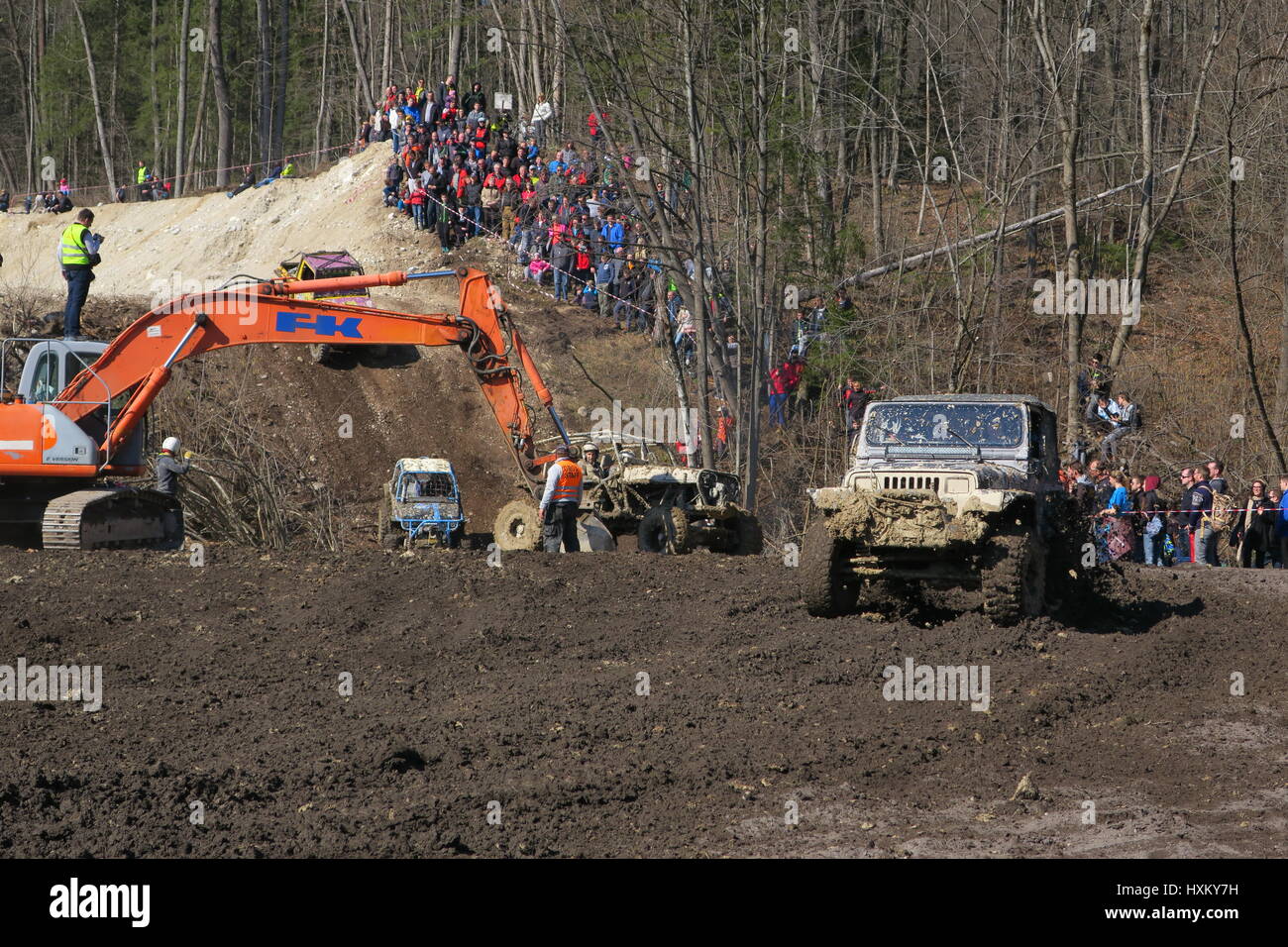 An excavator for pulling the off-road cars out of the muddy trench ...