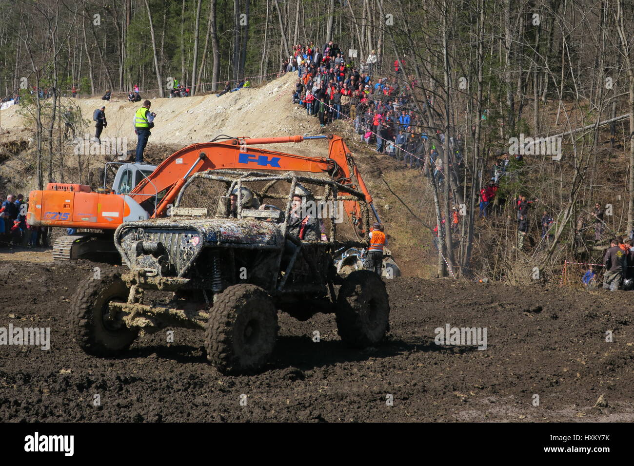 An excavator for pulling the off-road cars out of the muddy trench ...