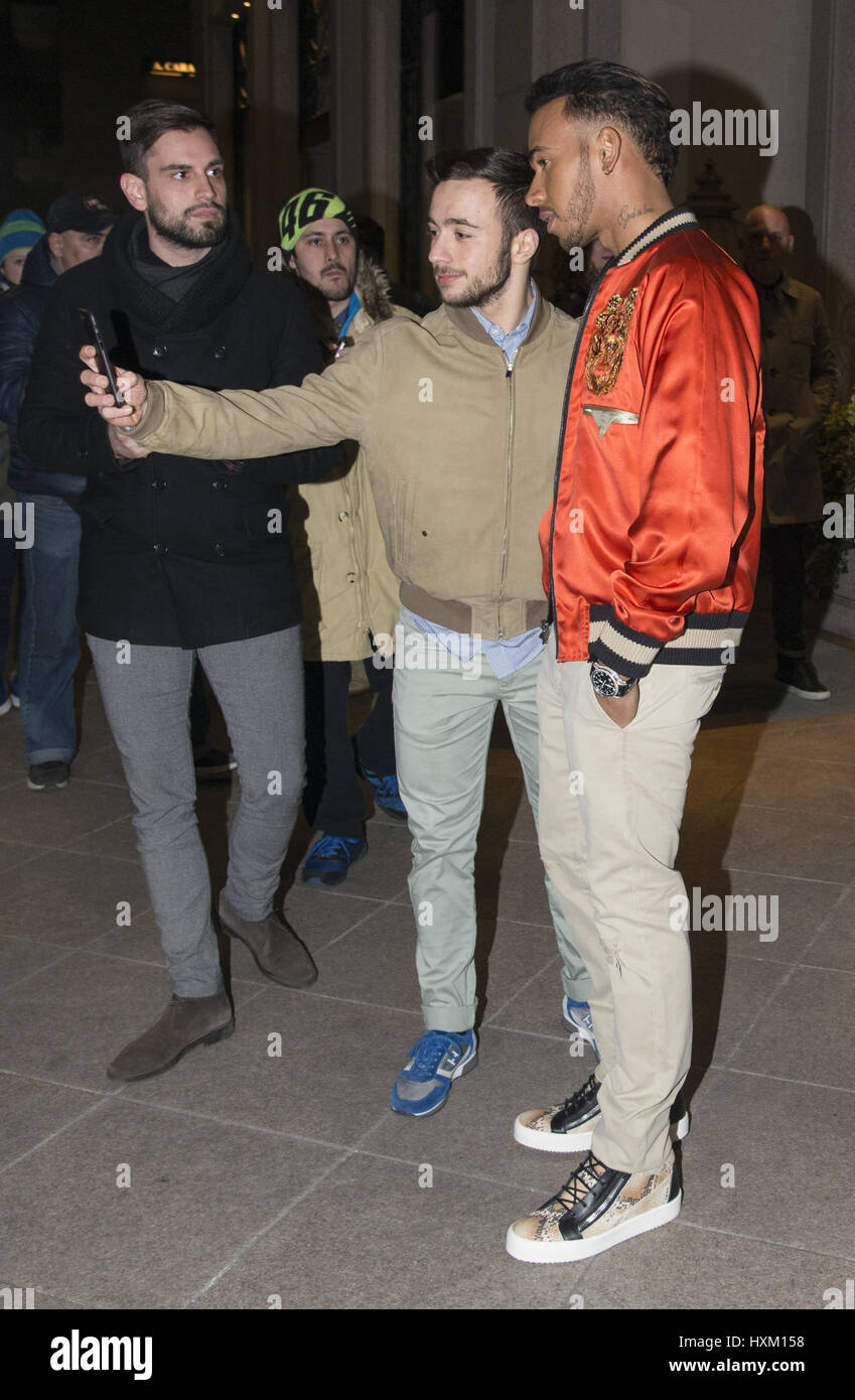 Lewis Hamilton poses for pictures with fans outside his hotel in Milan ...