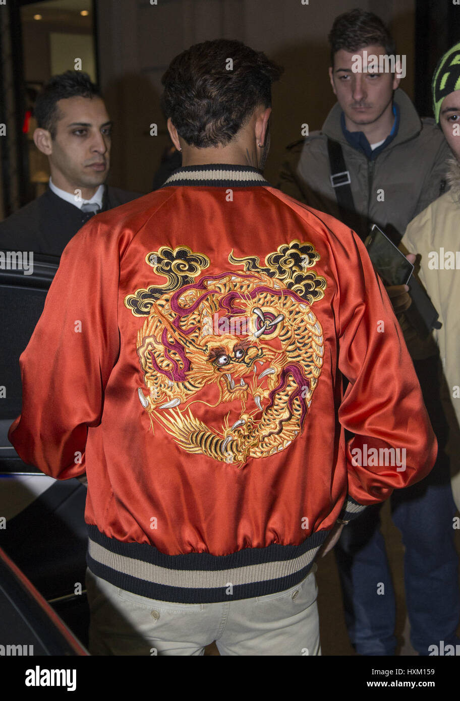 Lewis Hamilton poses for pictures with fans outside his hotel in Milan ...