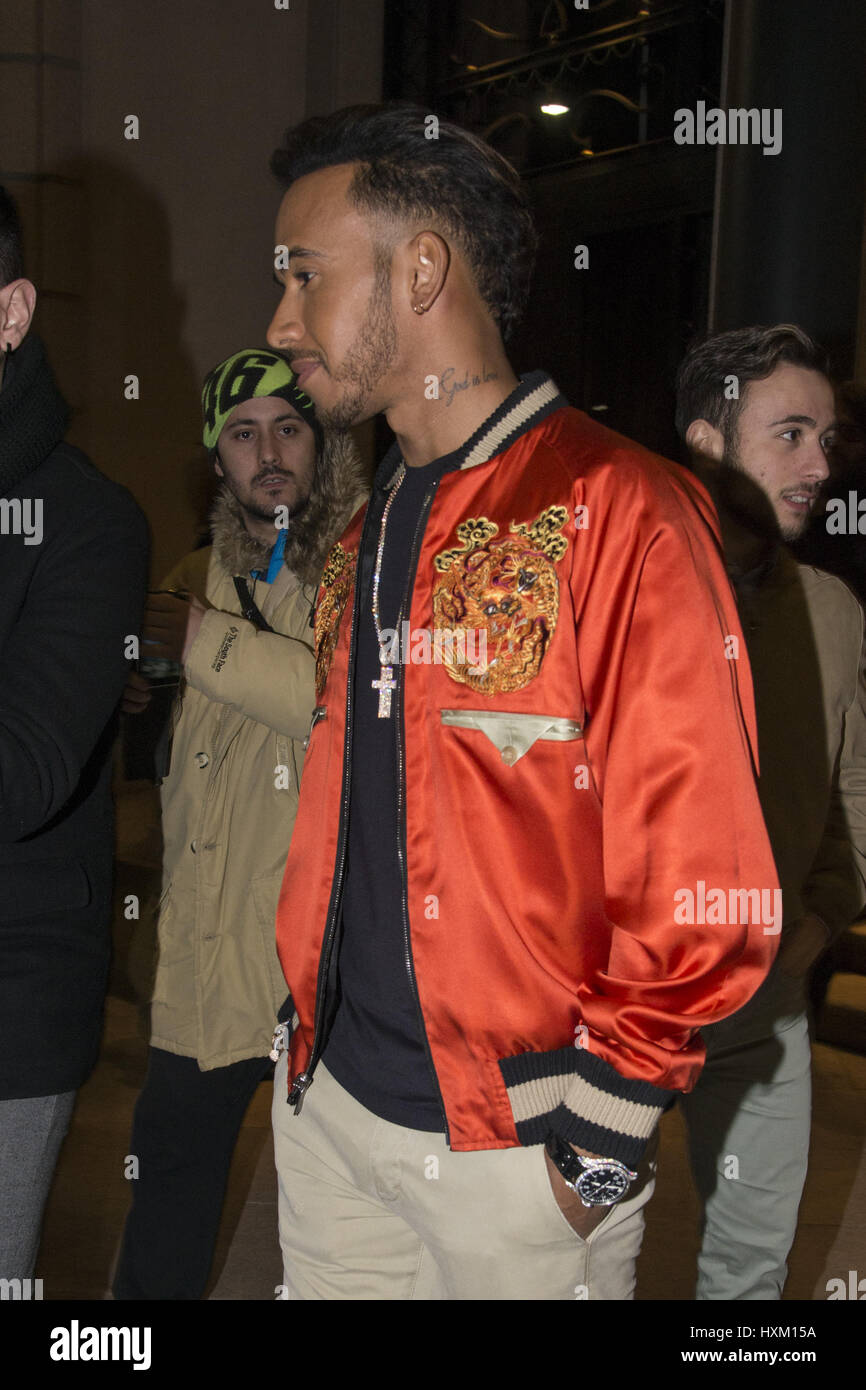 Lewis Hamilton poses for pictures with fans outside his hotel in Milan ...