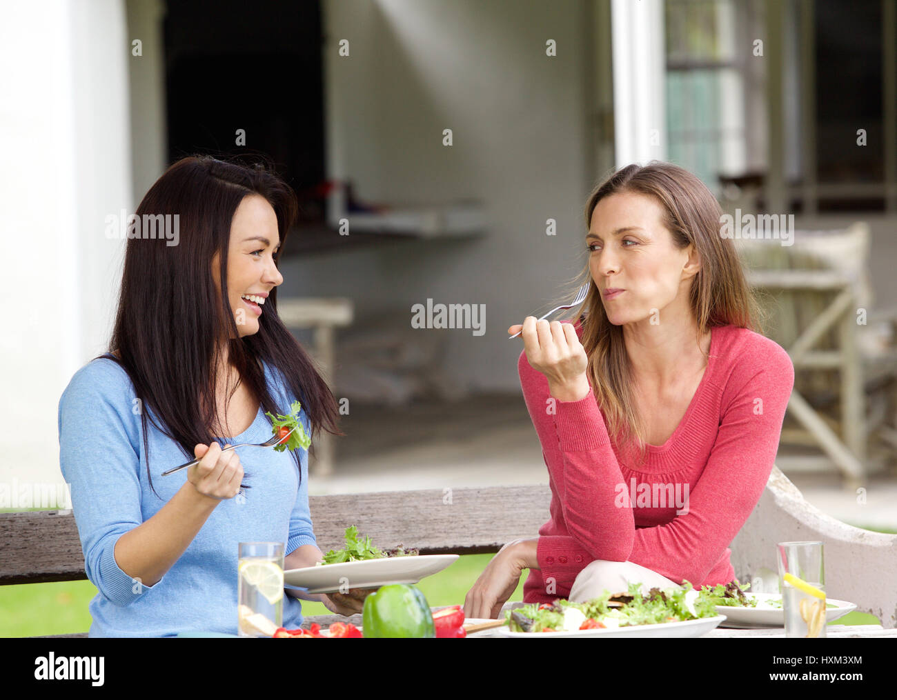 Portrait of two smiling friends enjoying lunch Stock Photo - Alamy