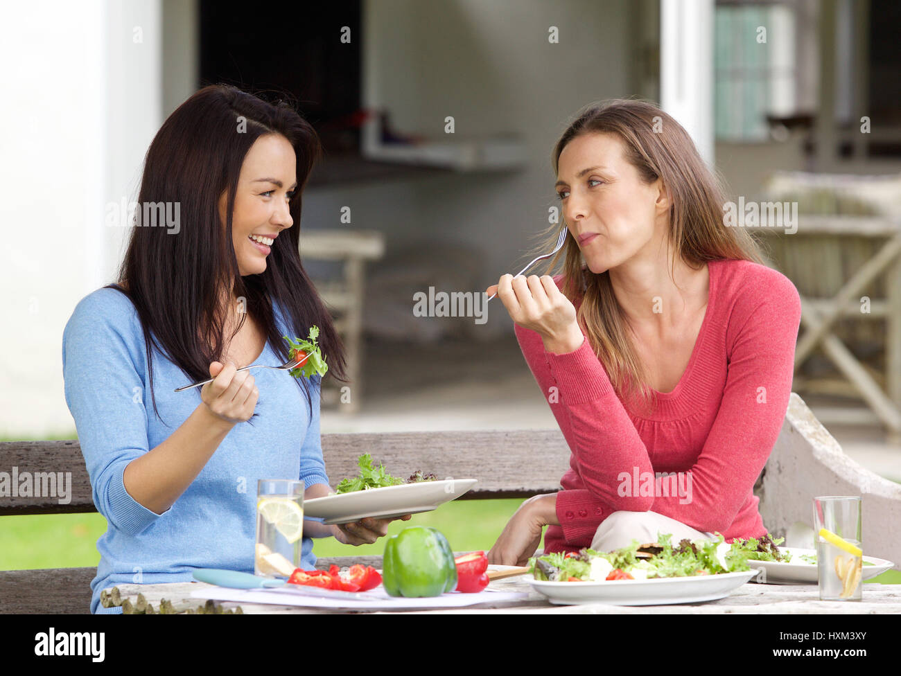Two friends eating together table hi-res stock photography and images ...