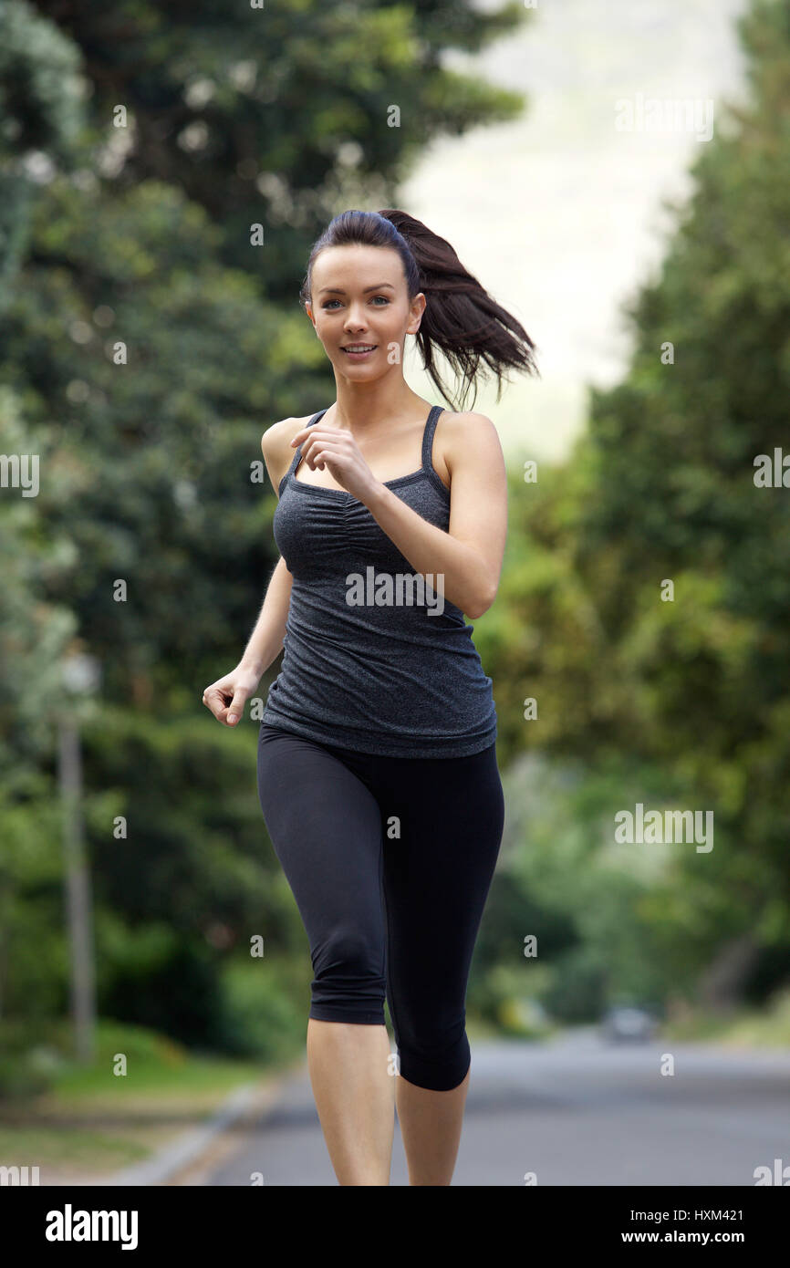 Portrait of a healthy woman running outside Stock Photo - Alamy