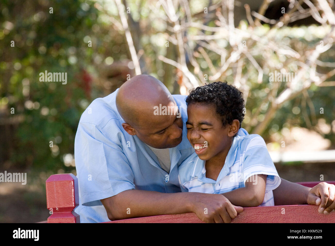 Portrait of an African American father and son outside at the park ...