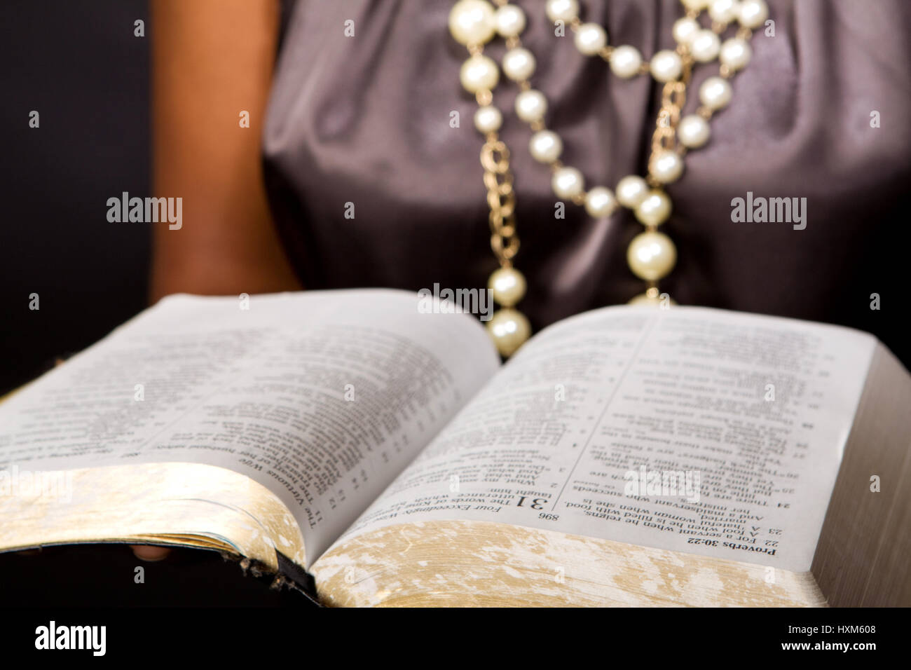 Woman reading the Bible isolated on black Stock Photo - Alamy