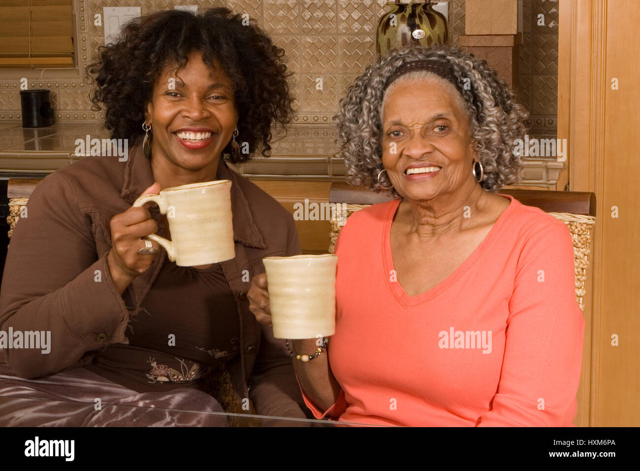 African American mother having coffee with her daughter Stock Photo - Alamy