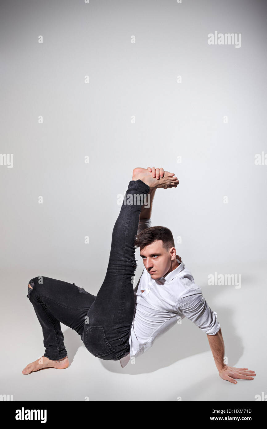 The young man dancing on gray Stock Photo - Alamy