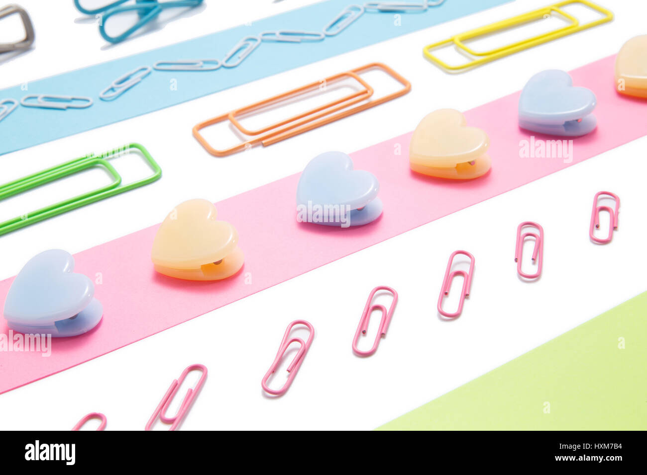 Coloured strips of paper with clips Stock Photo - Alamy
