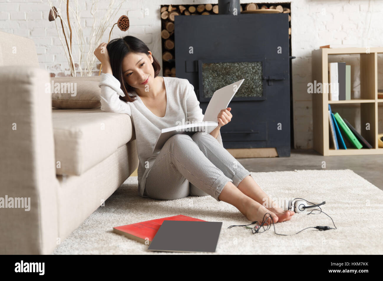 Young woman reading at home Stock Photo - Alamy