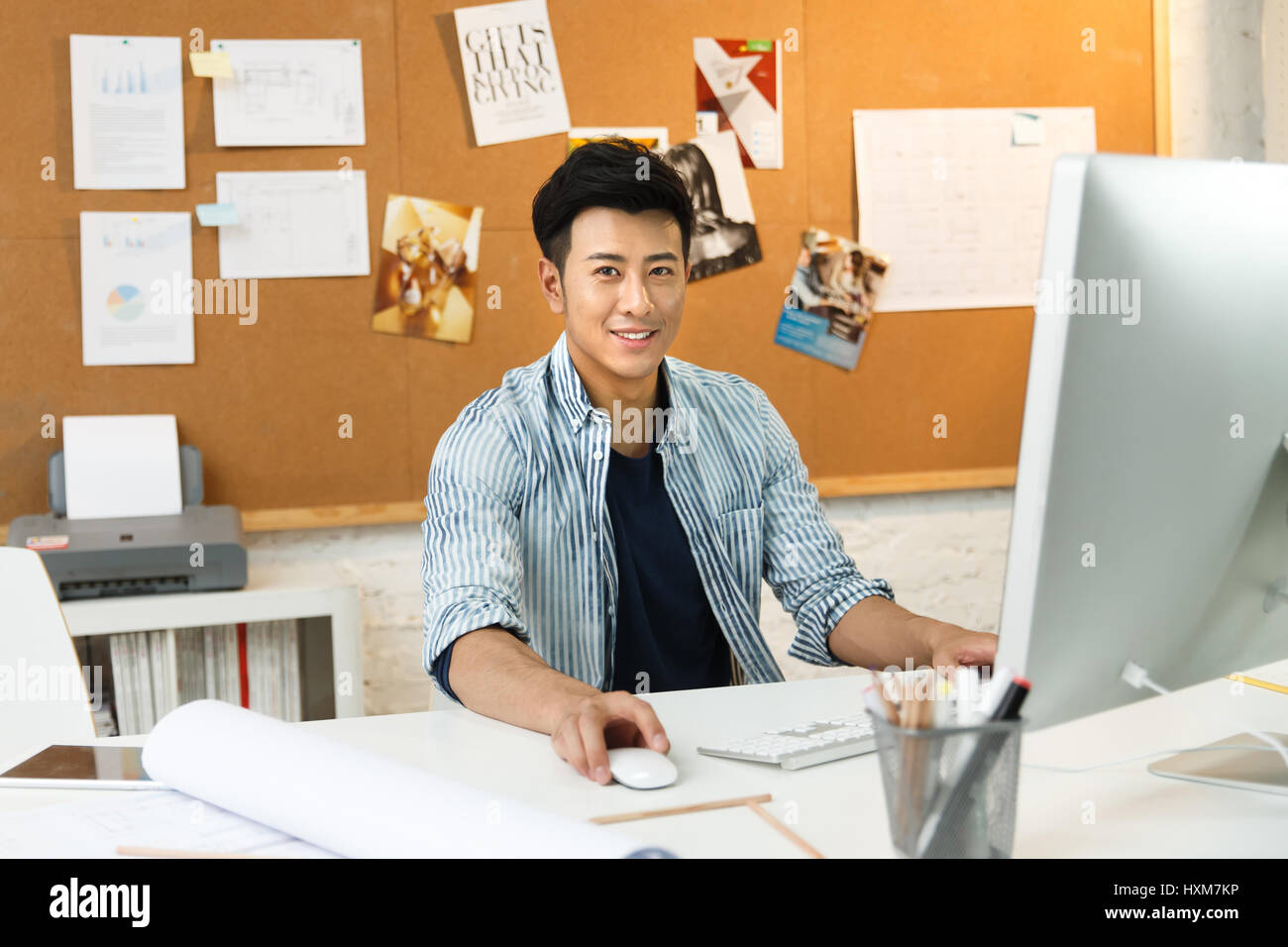 Young man using computer at home Stock Photo - Alamy