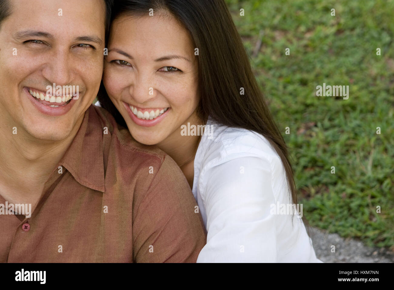 Beautiful happy couple laughing and hugging outside Stock Photo - Alamy