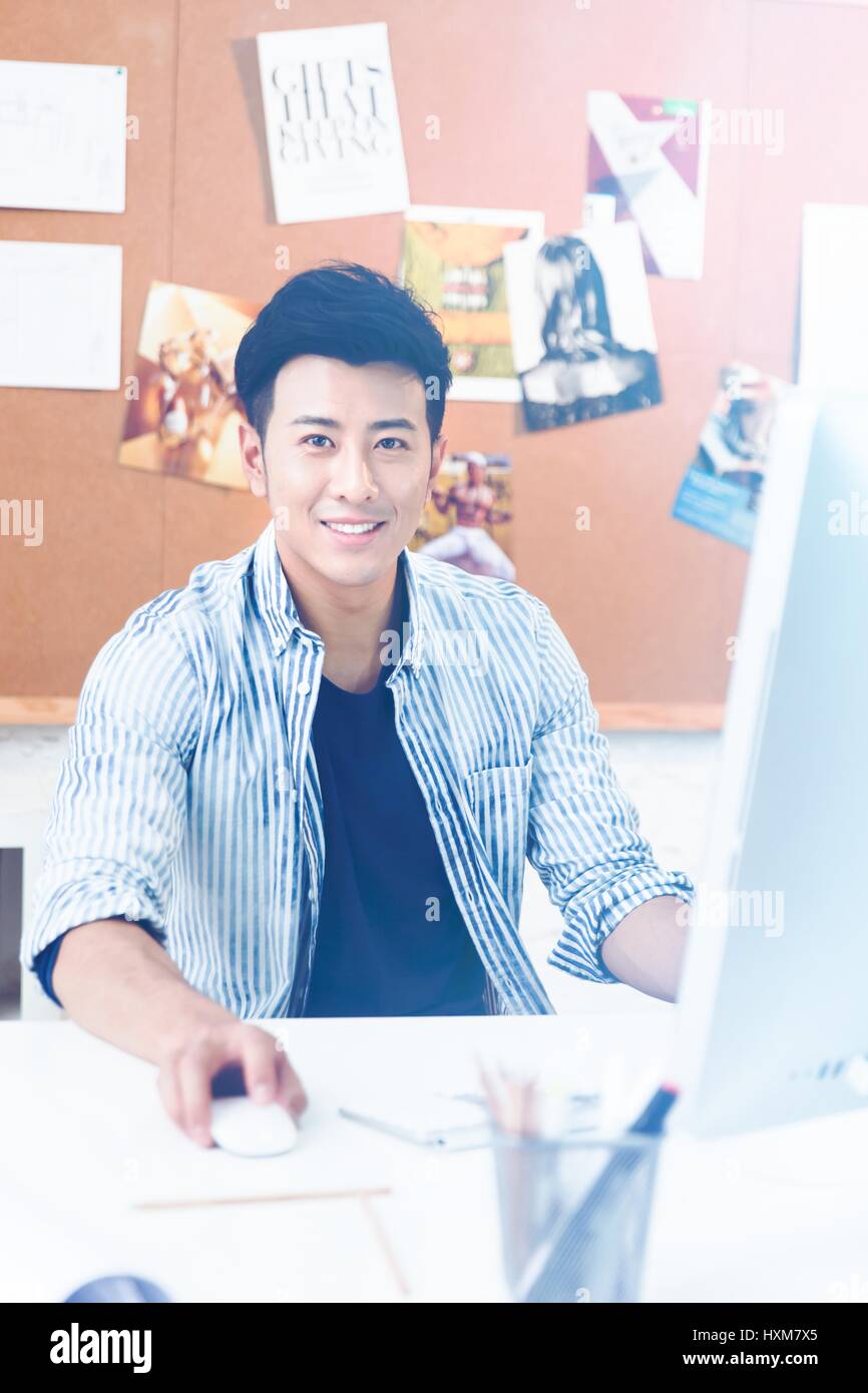 Young man using computer at home Stock Photo - Alamy