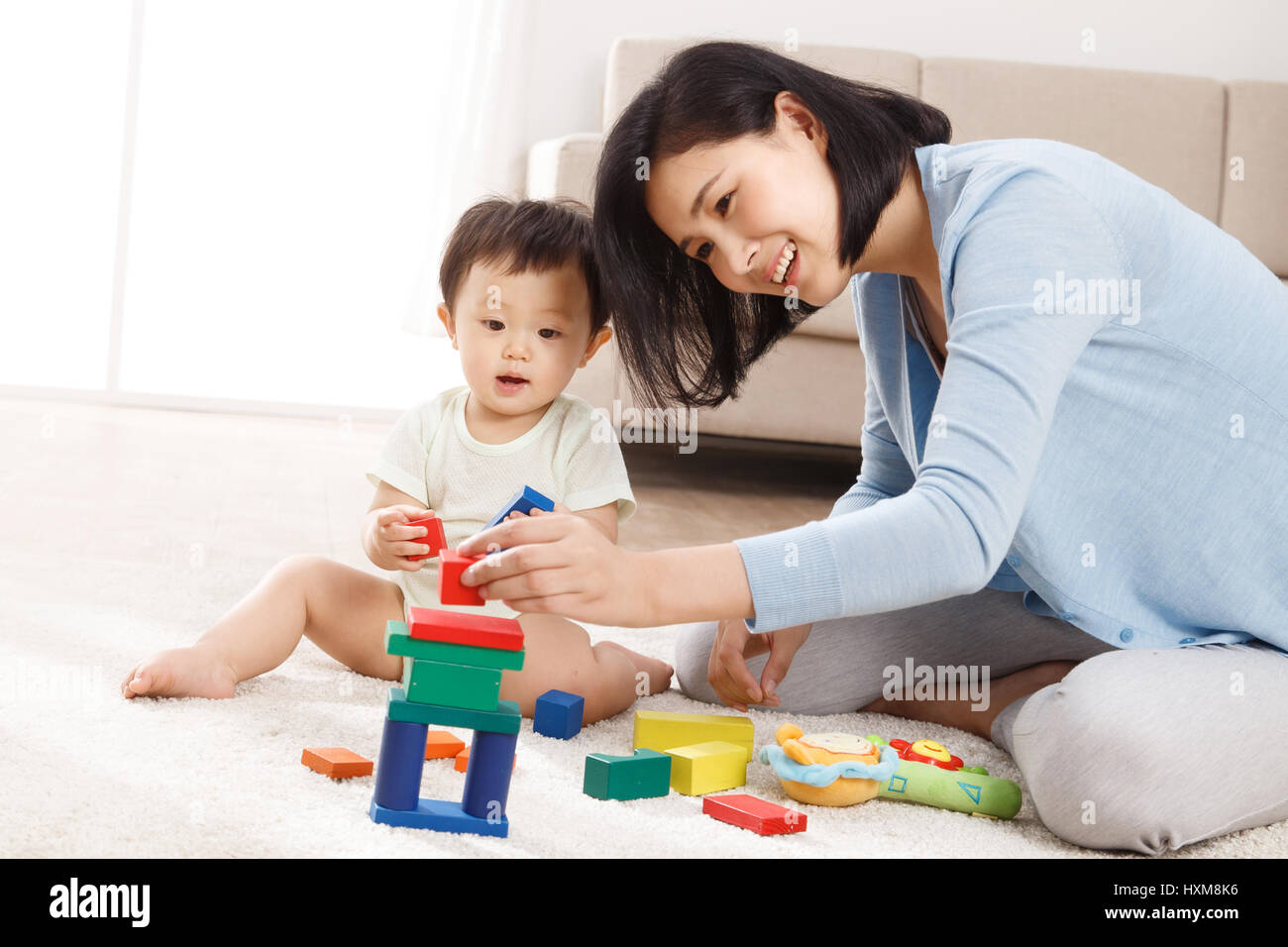 Mother playing with her baby Stock Photo - Alamy