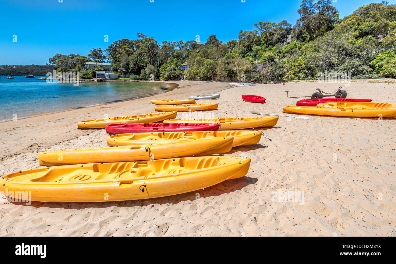 Yellow and red kayaks on the beach Stock Photo - Alamy