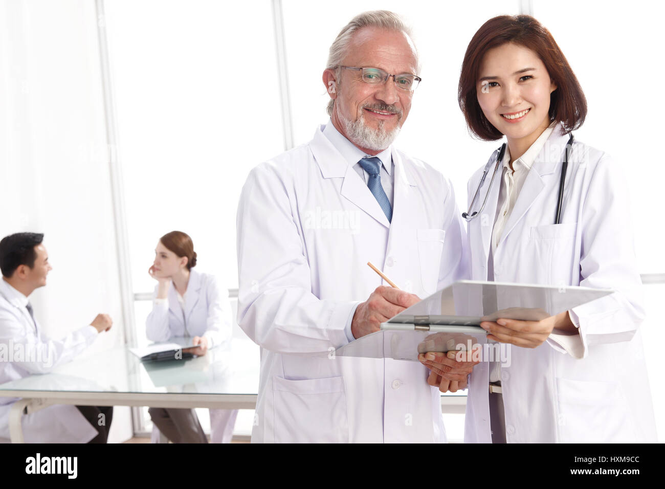 Doctors writing medical record Stock Photo - Alamy