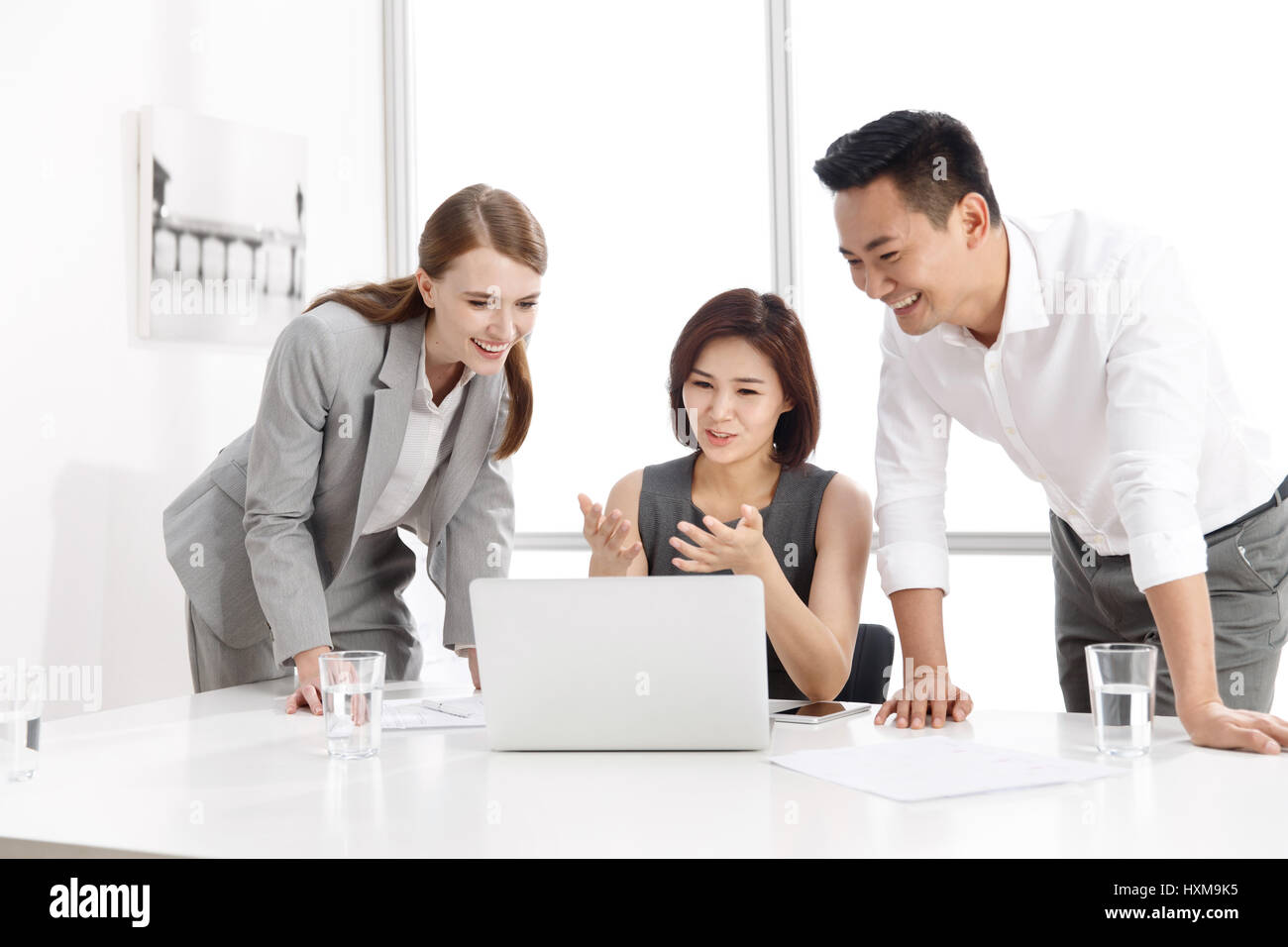 Three business people in office Stock Photo - Alamy