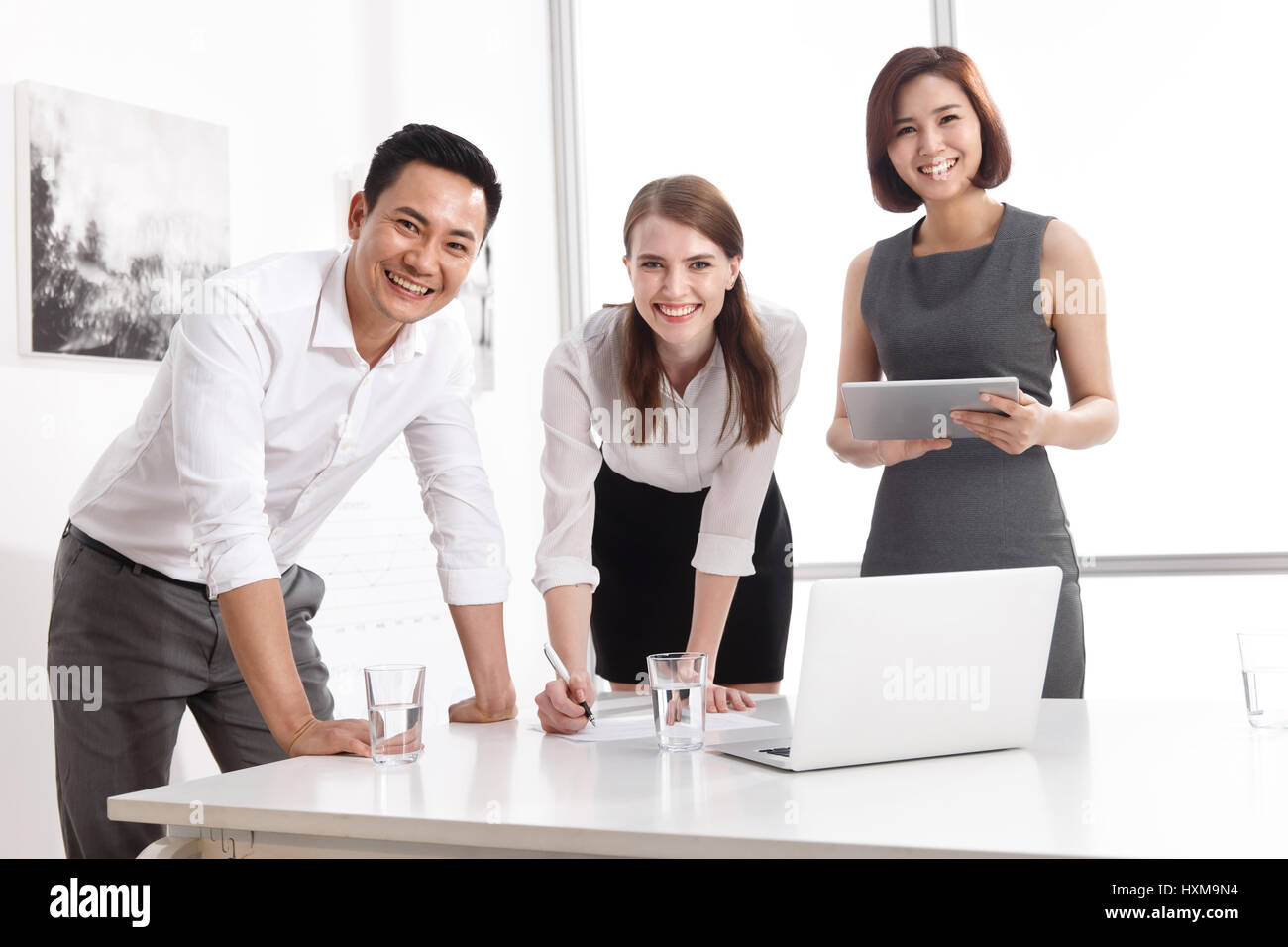 Three business people in office Stock Photo - Alamy