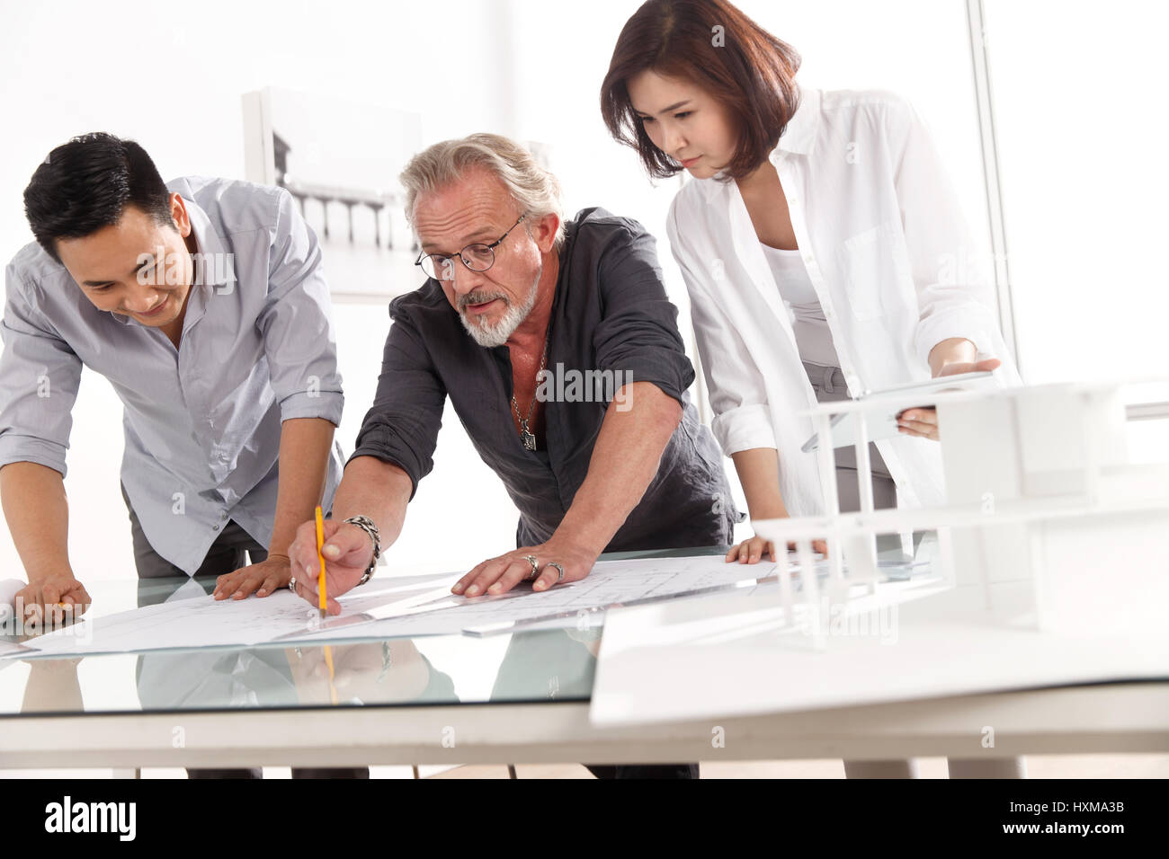 Architects working on blueprint Stock Photo - Alamy