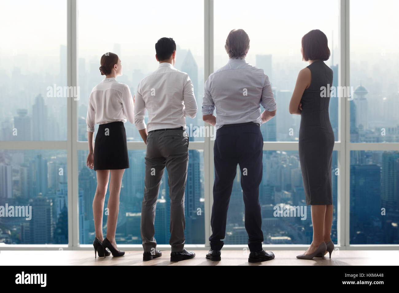 Business team looking out of window Stock Photo - Alamy