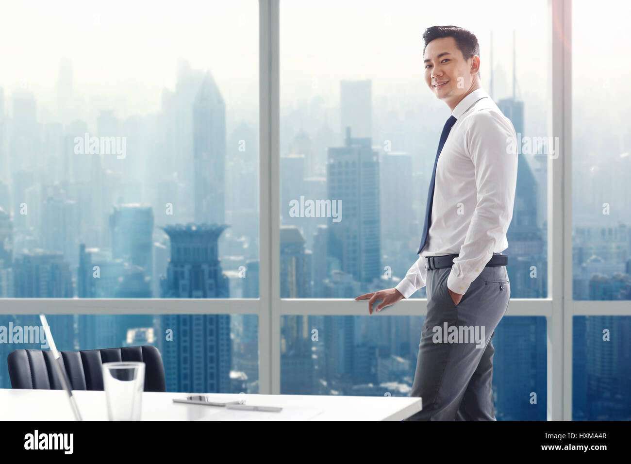 Businessman standing in office Stock Photo - Alamy